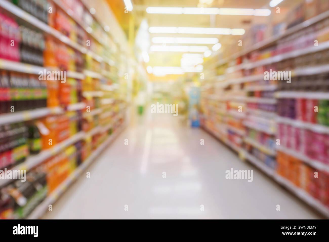 Abstract supermarket aisle with soft drink bottles product shelves ...