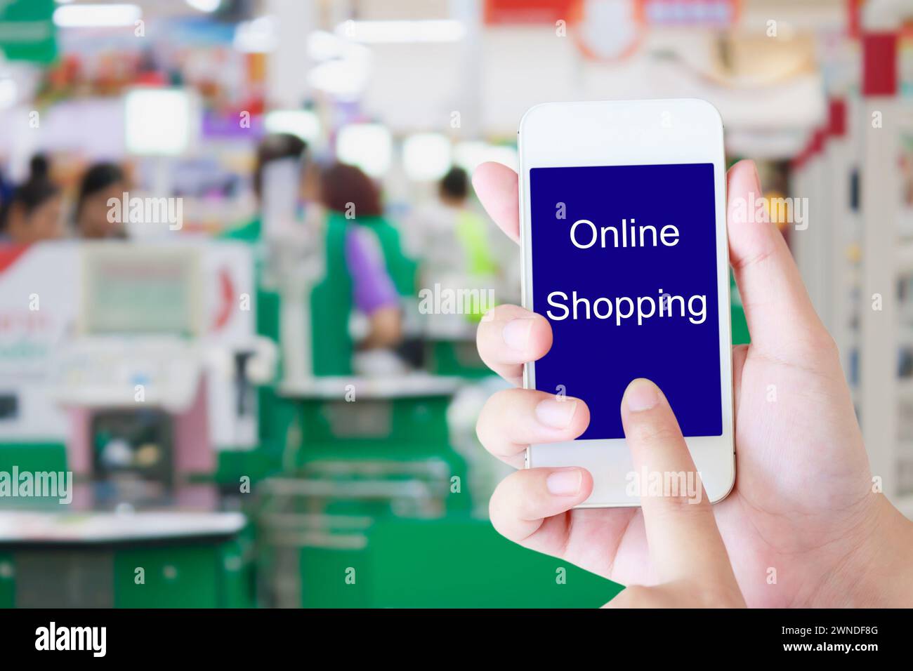 Hand holding mobile phone at supermarket checkout background, online ...
