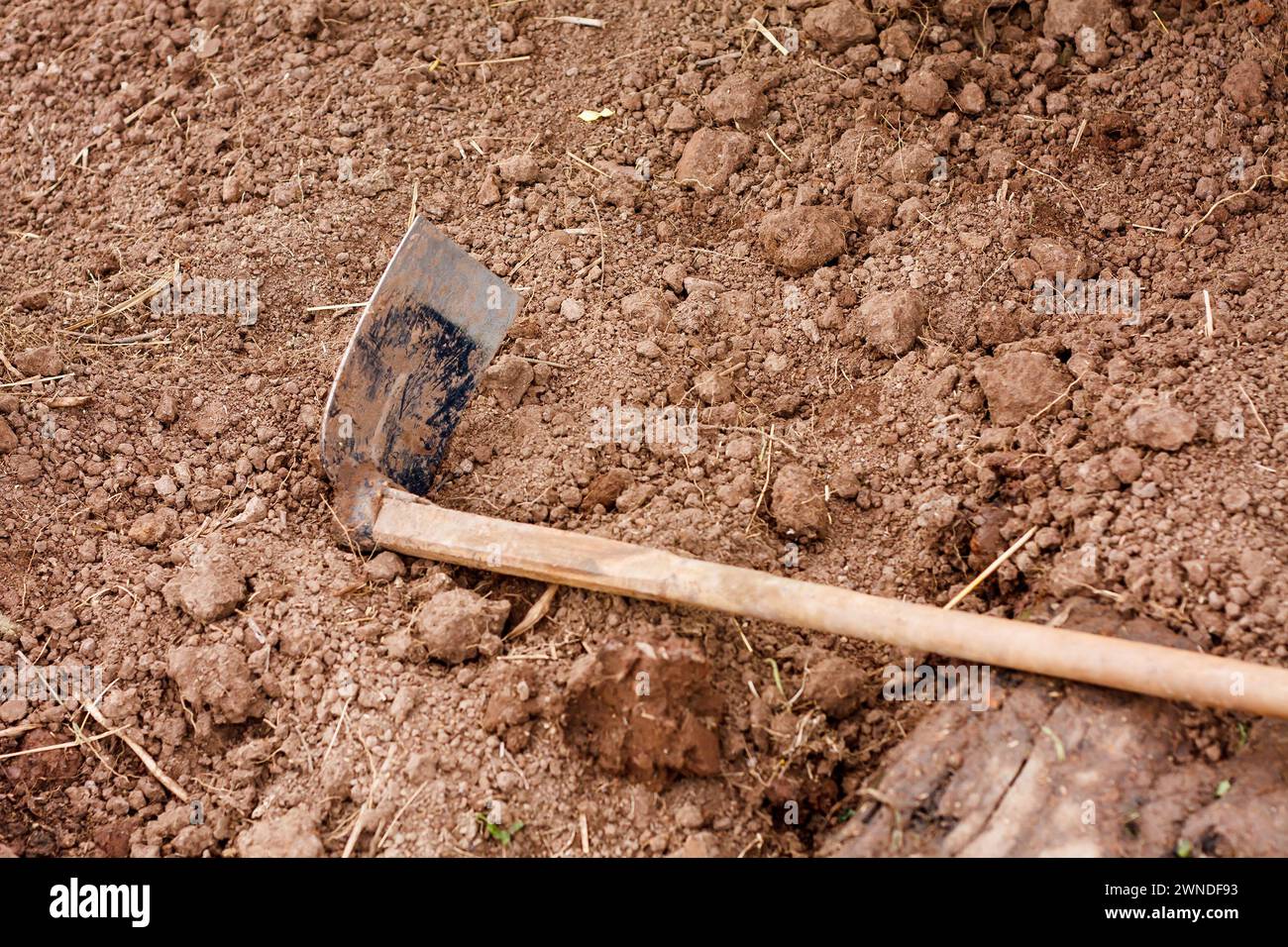 Soil with Hoe gardening tool Stock Photo - Alamy