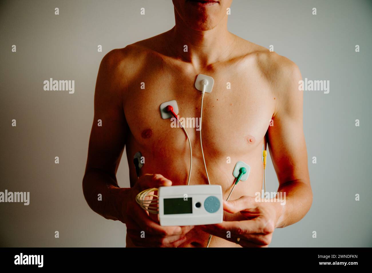 Candid capture of heart dynamics: EKG equipment on a young man ...