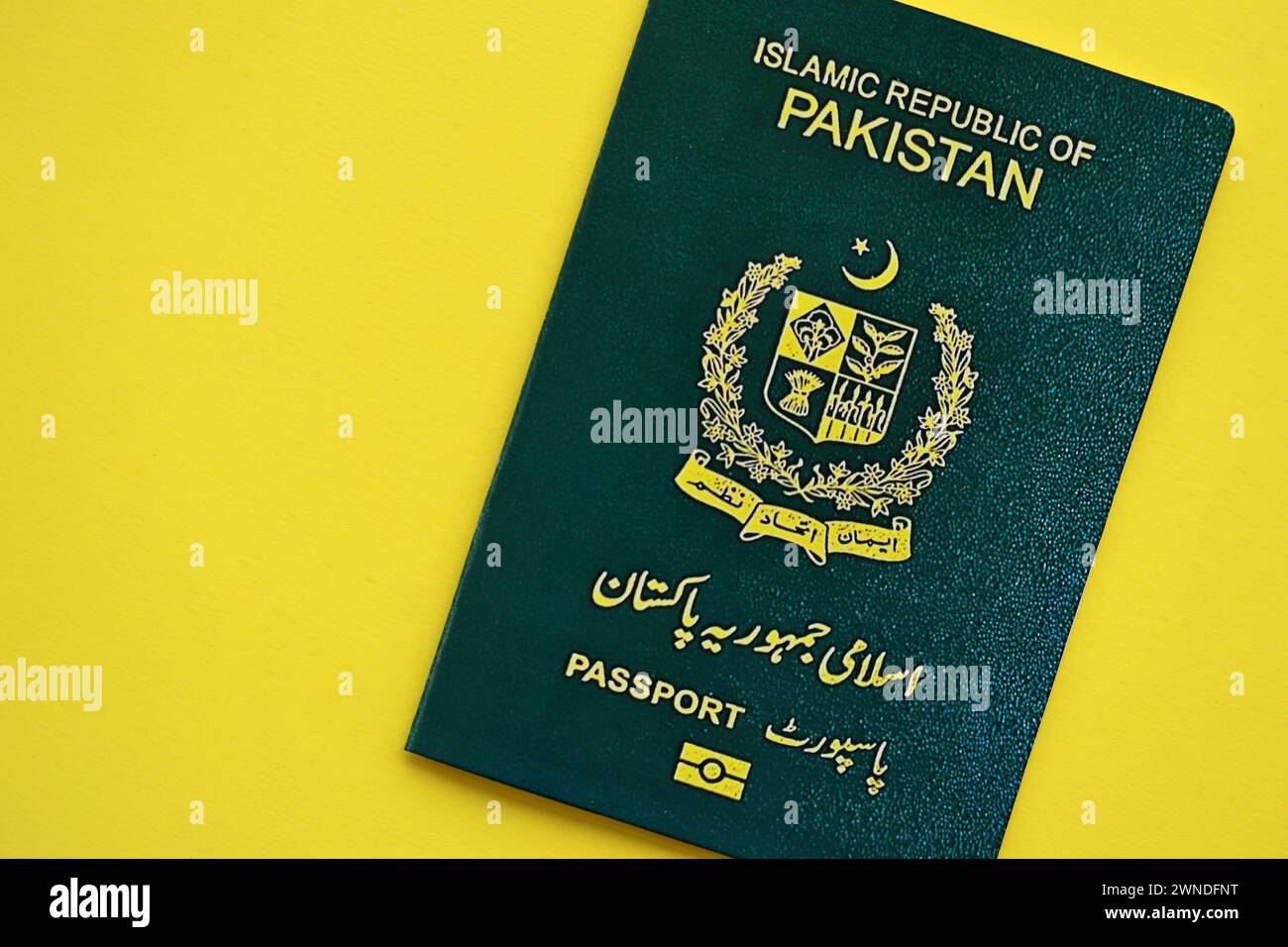 Green Islamic Republic of Pakistan passport on yellow background close ...