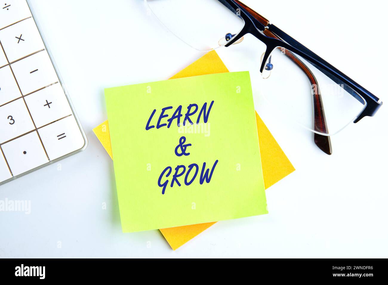 Learn and Grow written on a yellow sticker on a white background Stock ...
