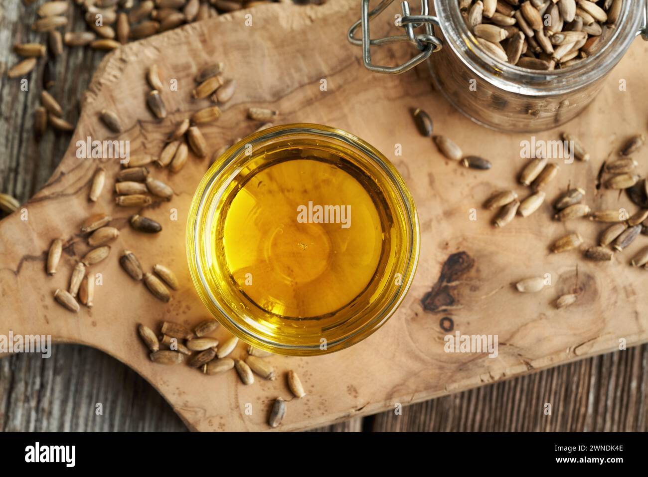 Milk thistle oil and seeds on a table, top view Stock Photo - Alamy