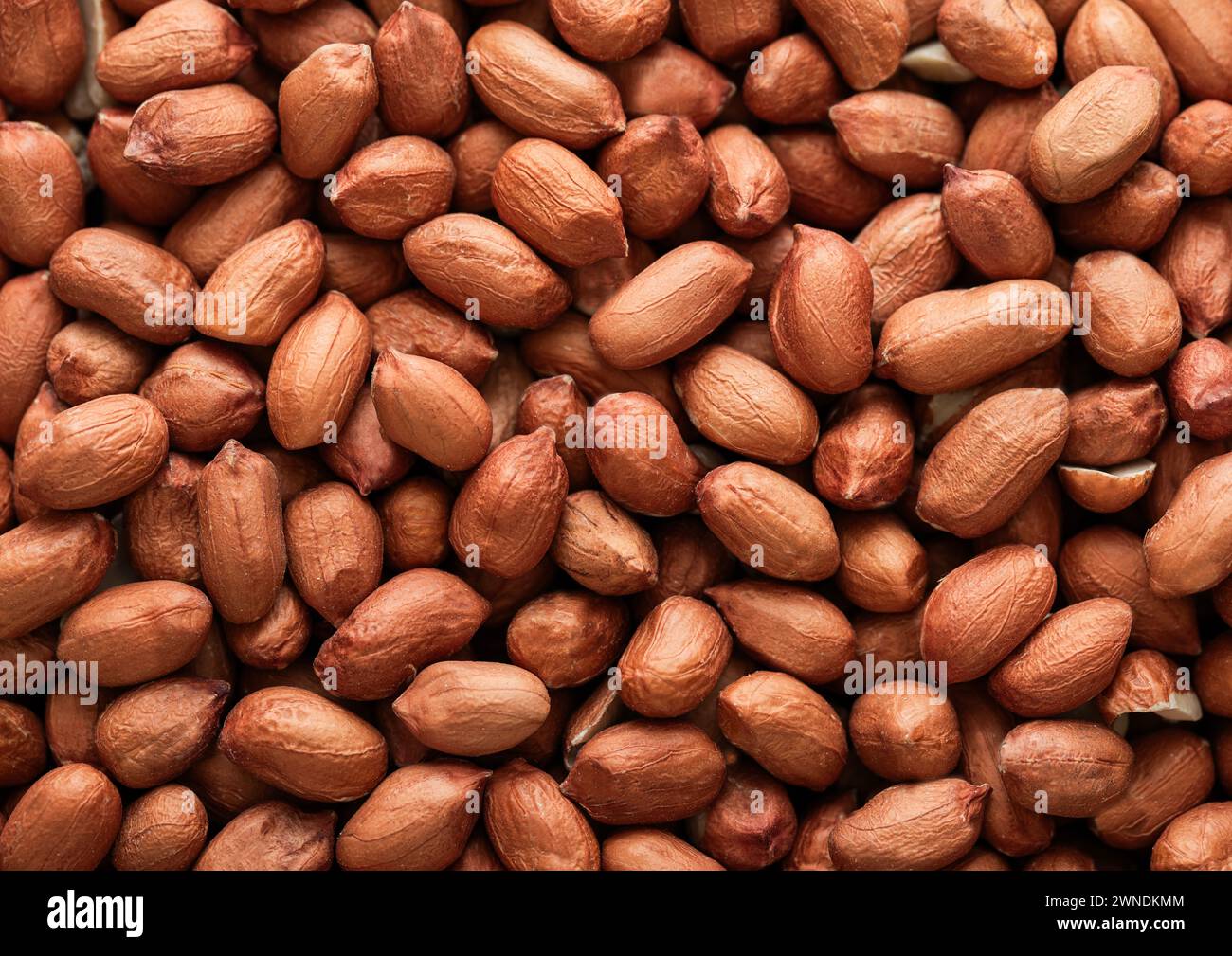 Raw peeled red peanut nuts top view macro background Stock Photo - Alamy