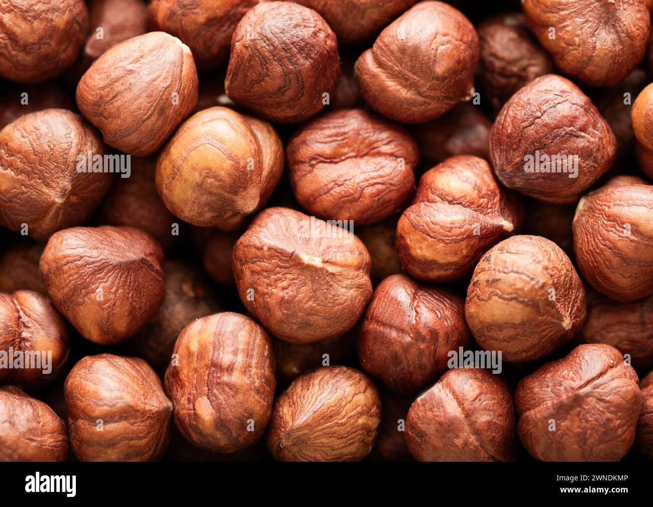 Raw peeled whole hazelnut nuts top view macro background Stock Photo ...