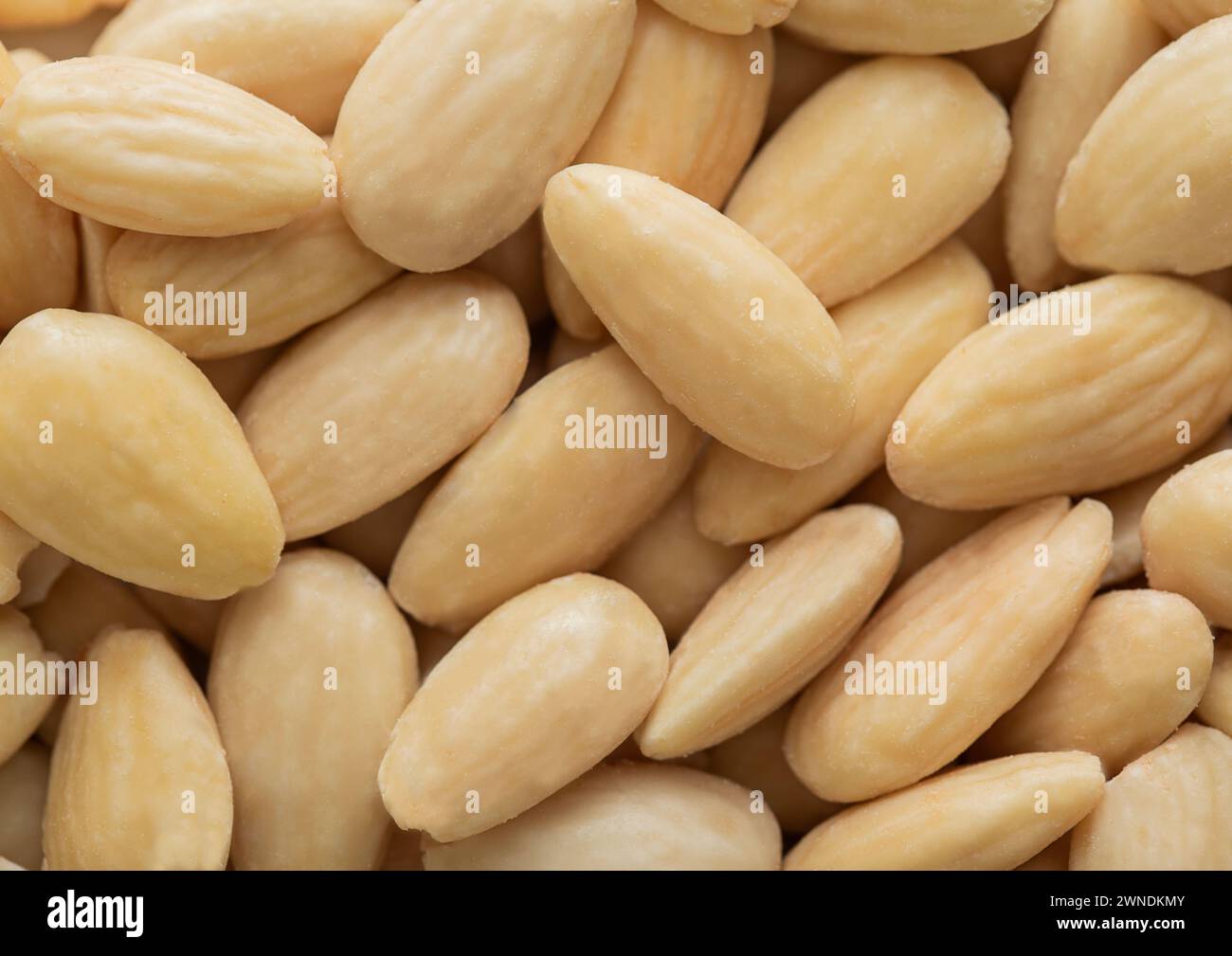 Healthy blanched almonds nuts top view macro background Stock Photo - Alamy