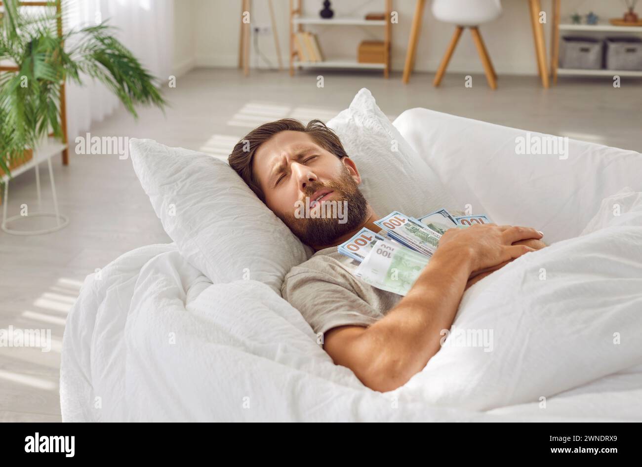 Man sleeping with dollar bills on chest, having bad dream about money ...