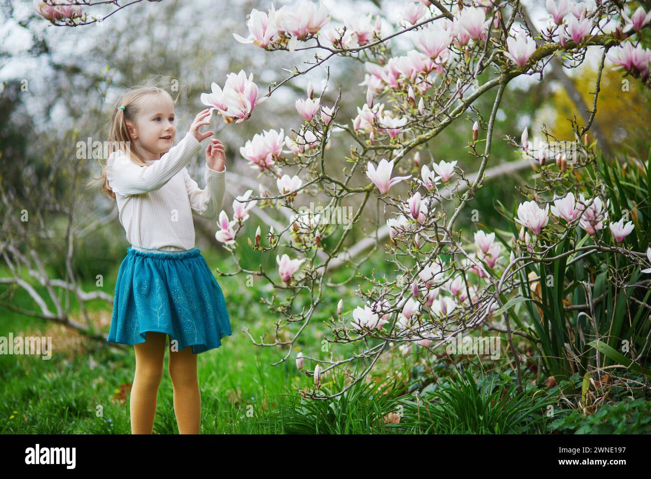 Adorable preschooler girl enjoying nice spring day in park during ...