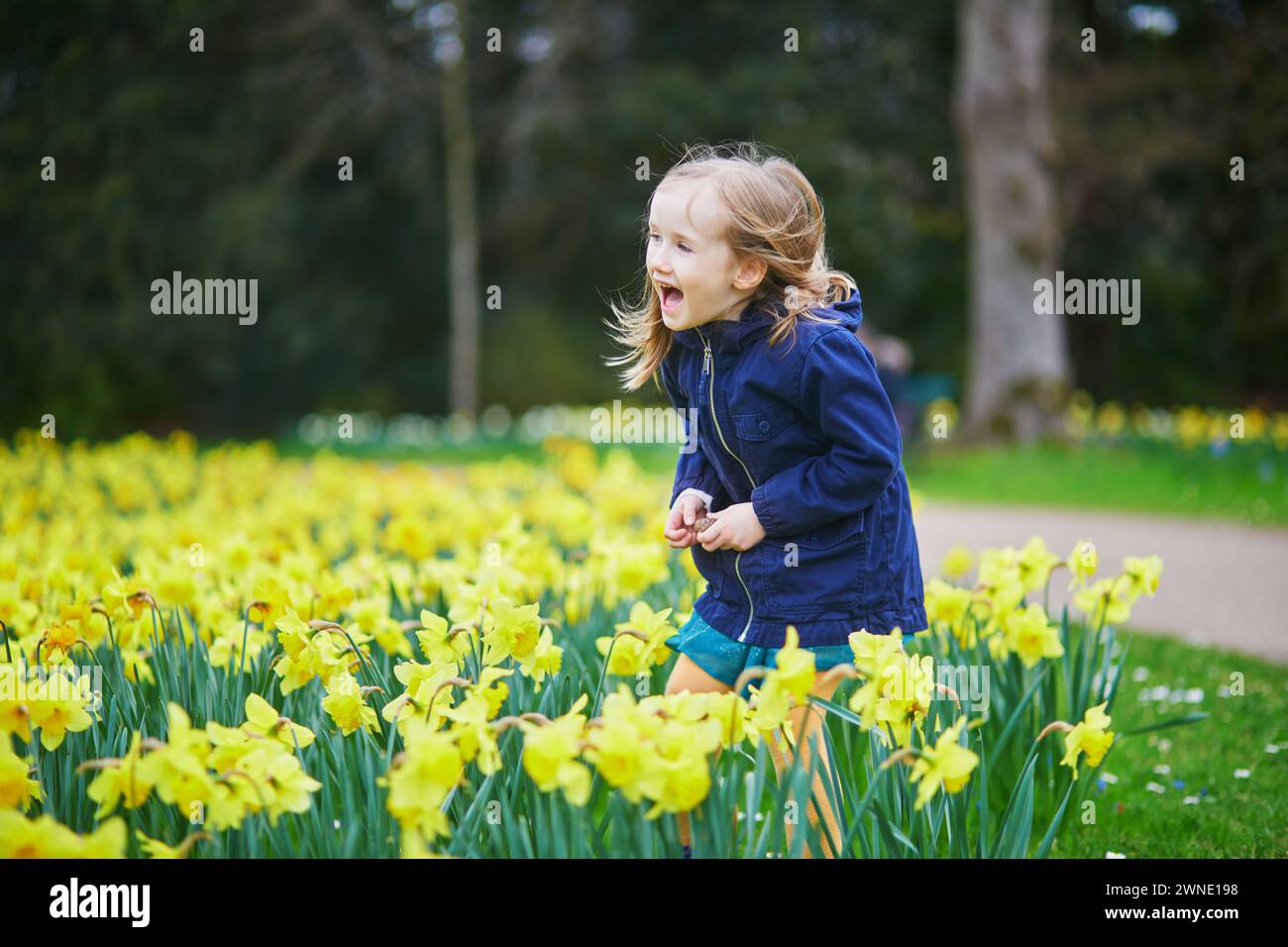 Adorable preschooler girl enjoying nice spring day in park during ...