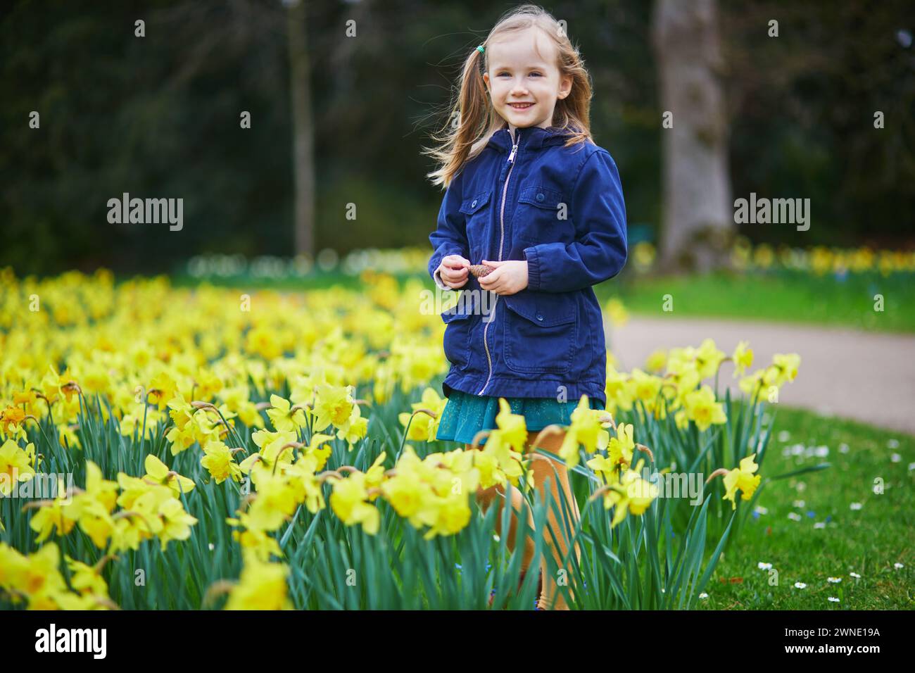 Adorable preschooler girl enjoying nice spring day in park during ...