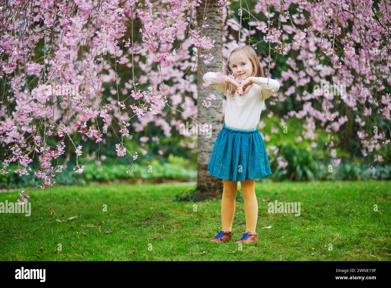 Adorable preschooler girl enjoying nice spring day in park during ...