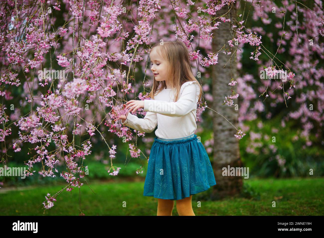Adorable preschooler girl enjoying nice spring day in park during ...