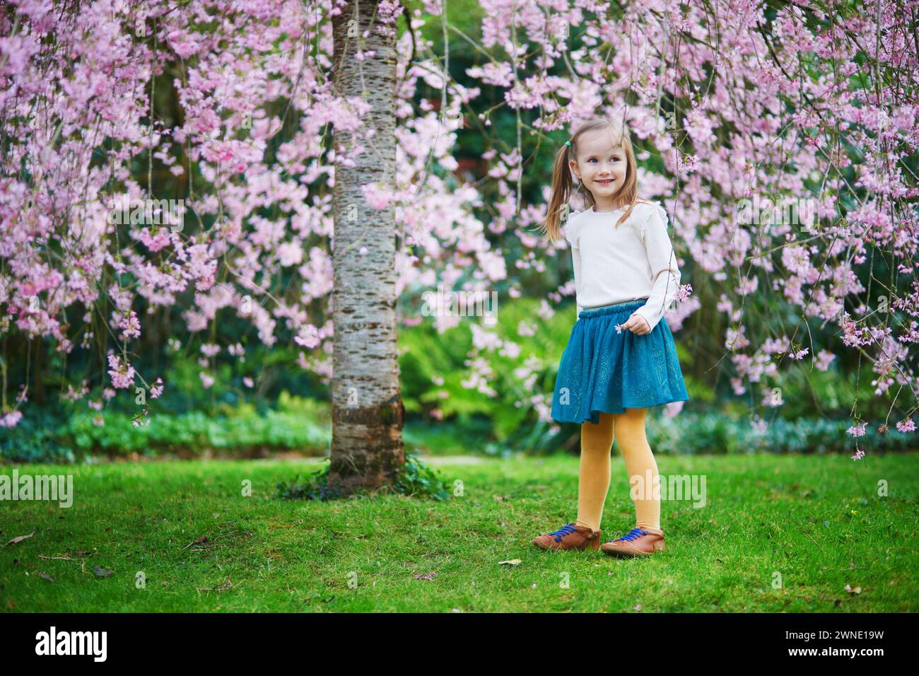 Adorable preschooler girl enjoying nice spring day in park during ...