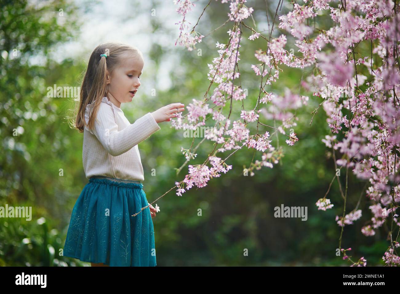 Adorable preschooler girl enjoying nice spring day in park during ...