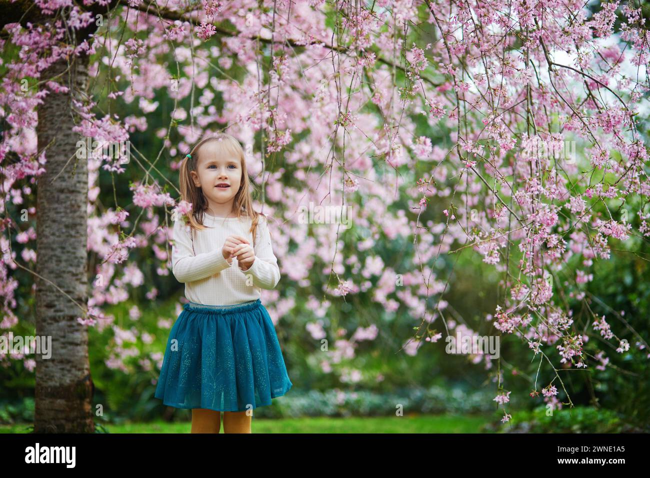Adorable preschooler girl enjoying nice spring day in park during ...
