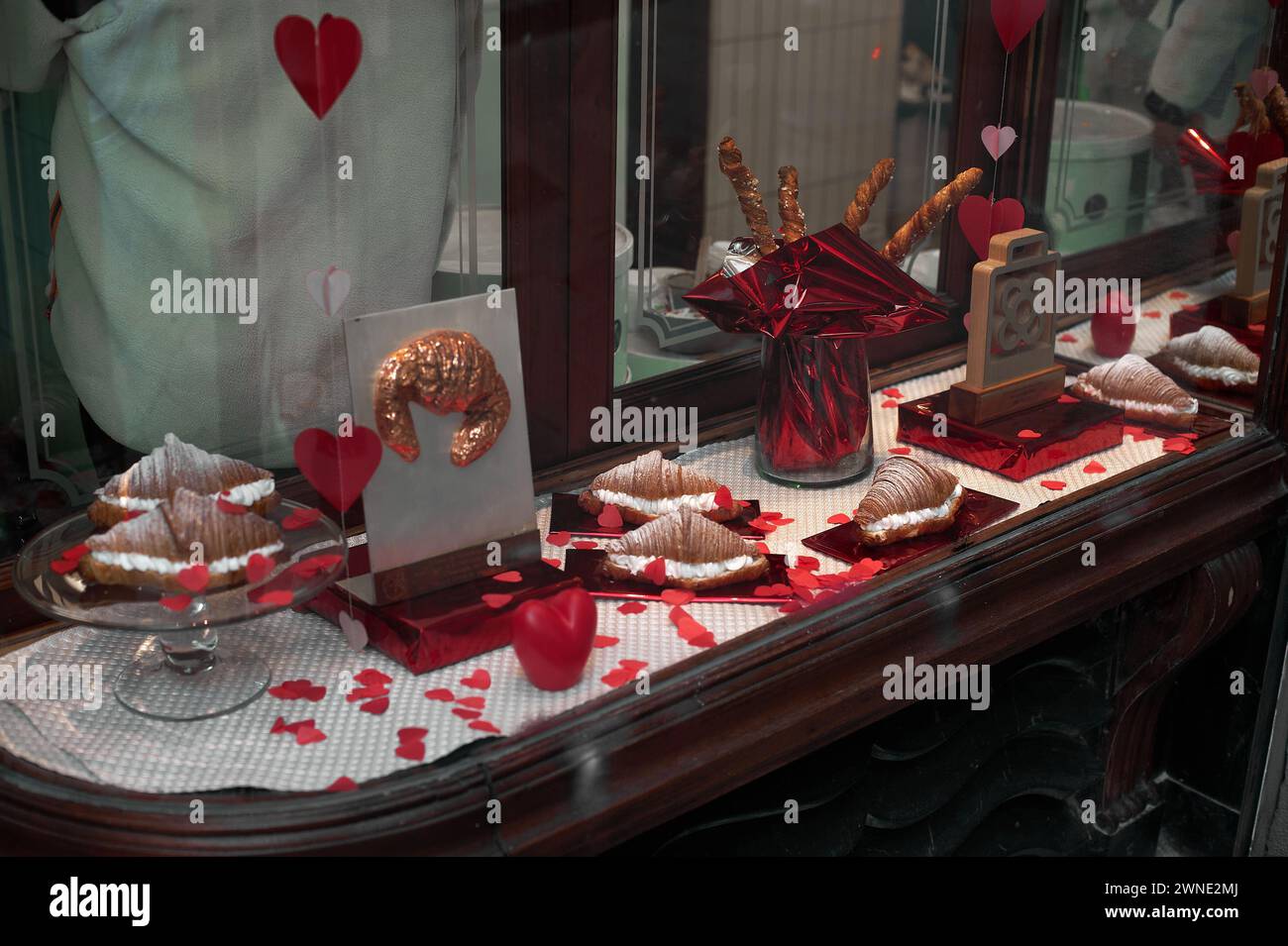 Display case adorned with hearts, displaying Valentine's themed sweets ...