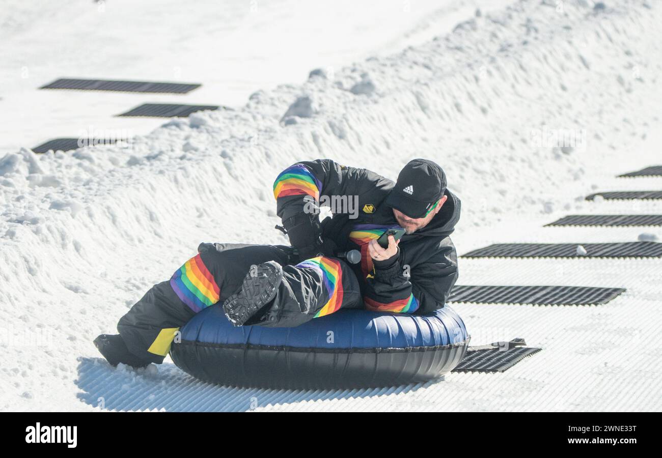 Casey Fosbenner reacts after tubing down the mountain during the 2024 ...