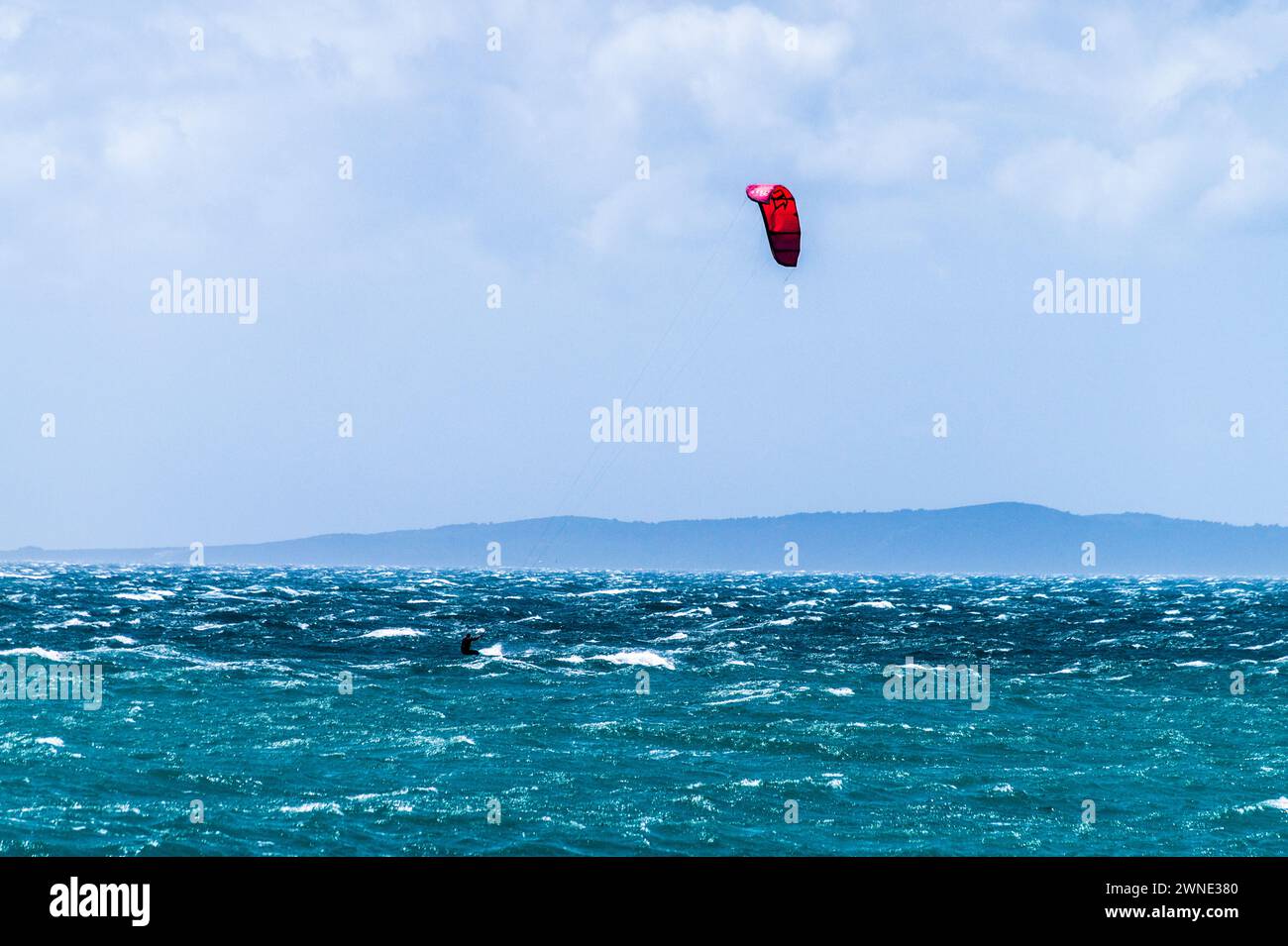 A kite surfer airborne in stormy weather at Znan city beach, Split ...