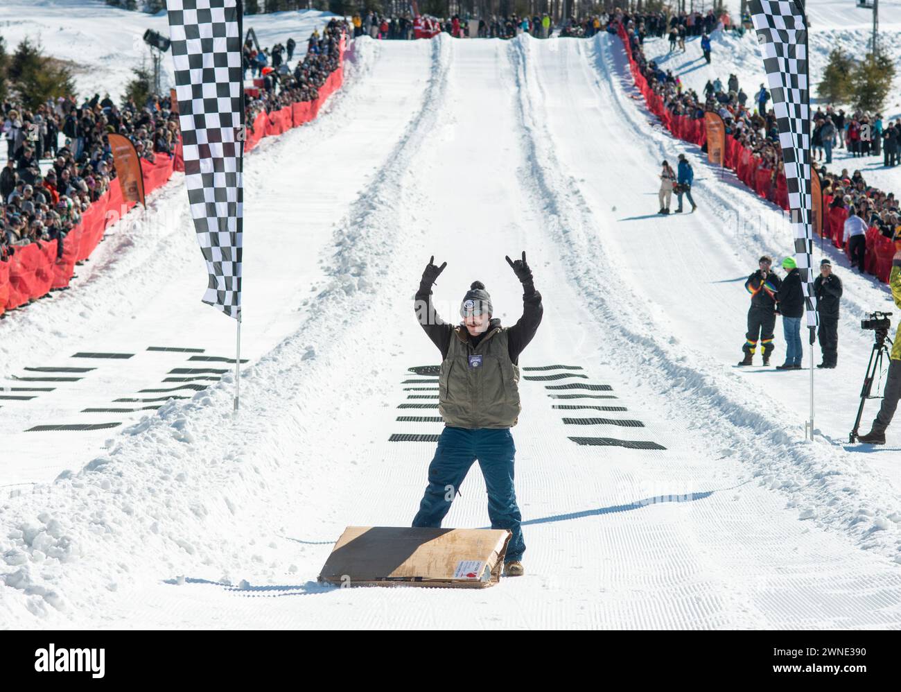 PArticipants react after sledding down the mountain during the 2024 ...