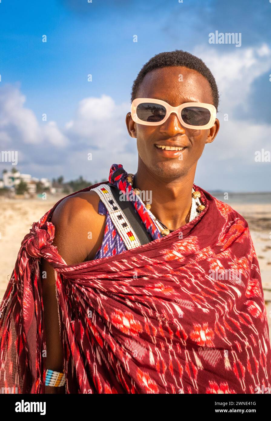 A young Maasai warrior in a traditional shuka on Jambiani beach ...