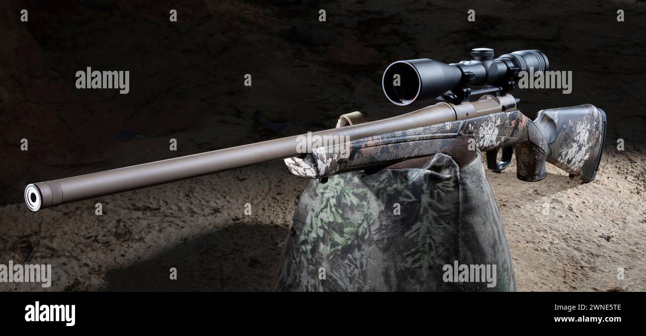 Darkness around a centerfire hunting rifle with high powered scope just ...