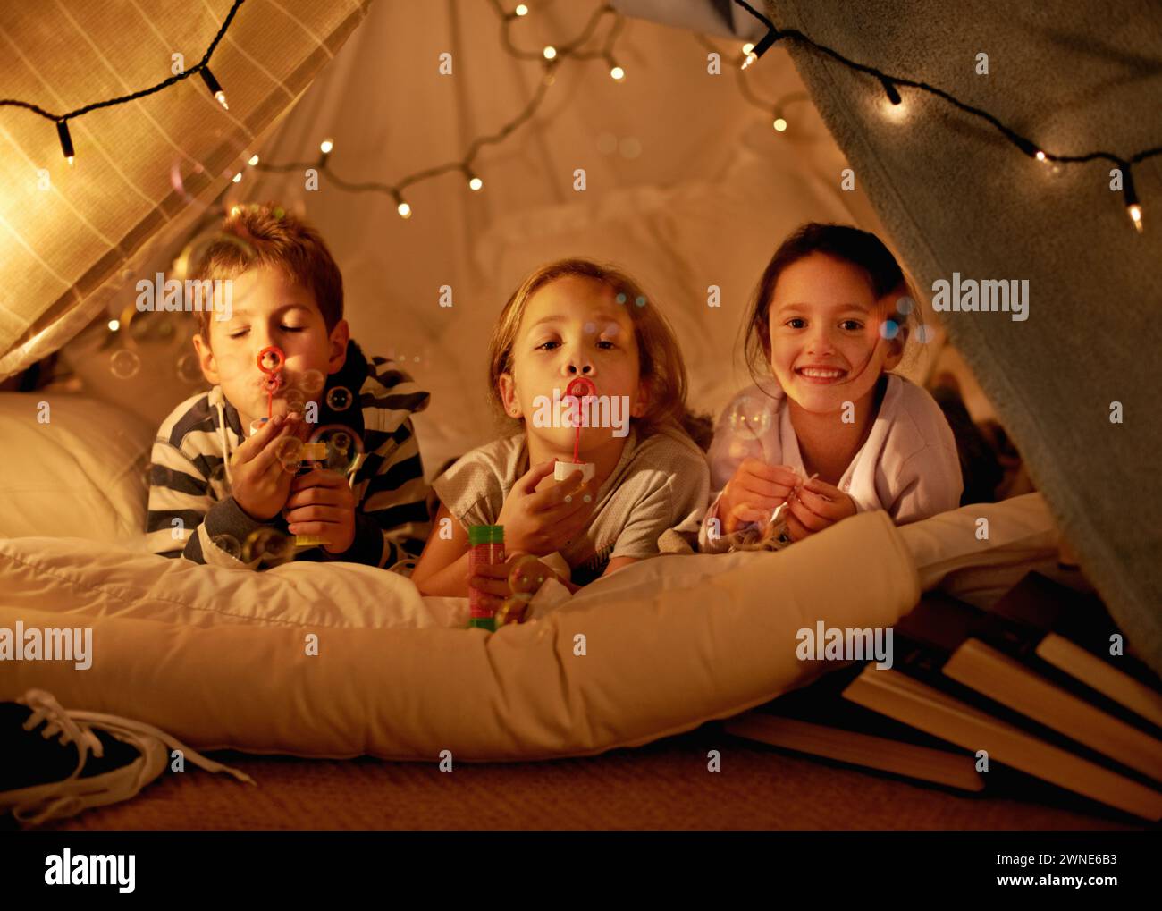 Children, fort and portrait of siblings in a bed with fun, toy and ...