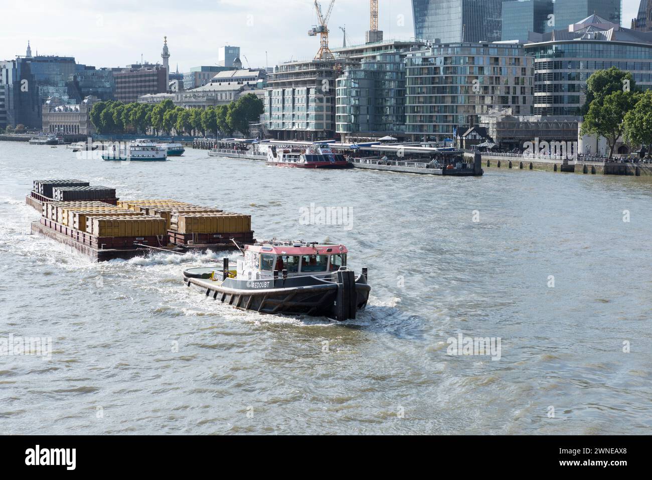 UK, London, barge removing waste along the river Thames near London ...