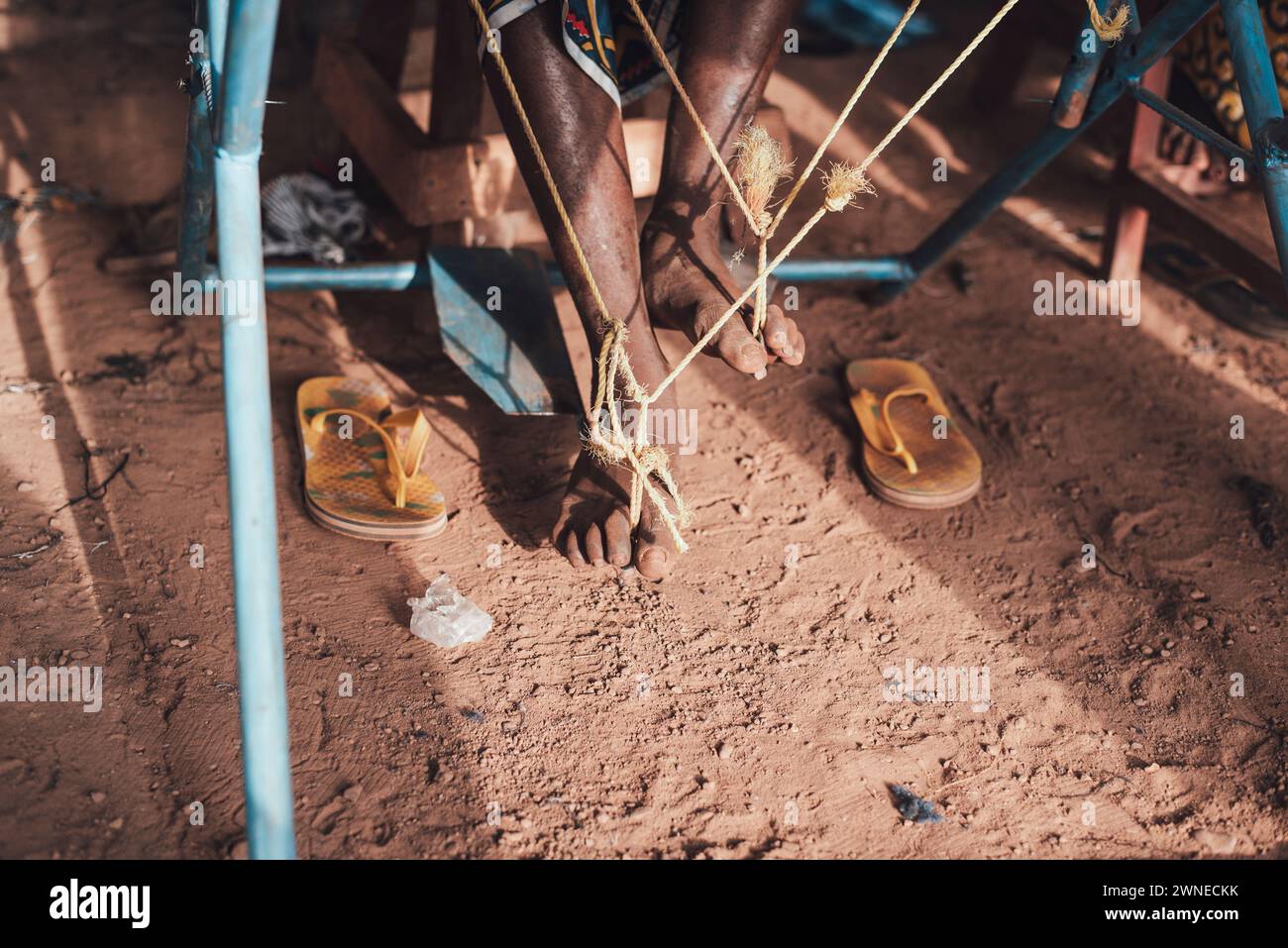 Ouagadougou, Burkina Faso. December 2017. Detail of worker's feet ...