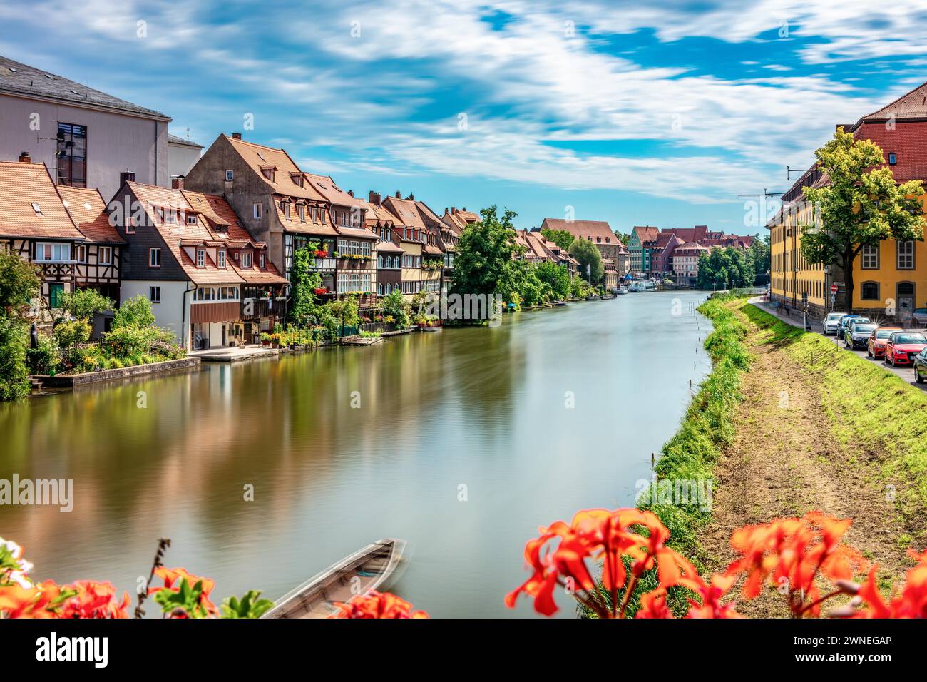 View of a quiet riverside town with traditional architecture and nature ...