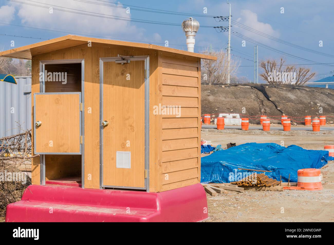 Front exterior of public restroom in front oft rural construction site ...