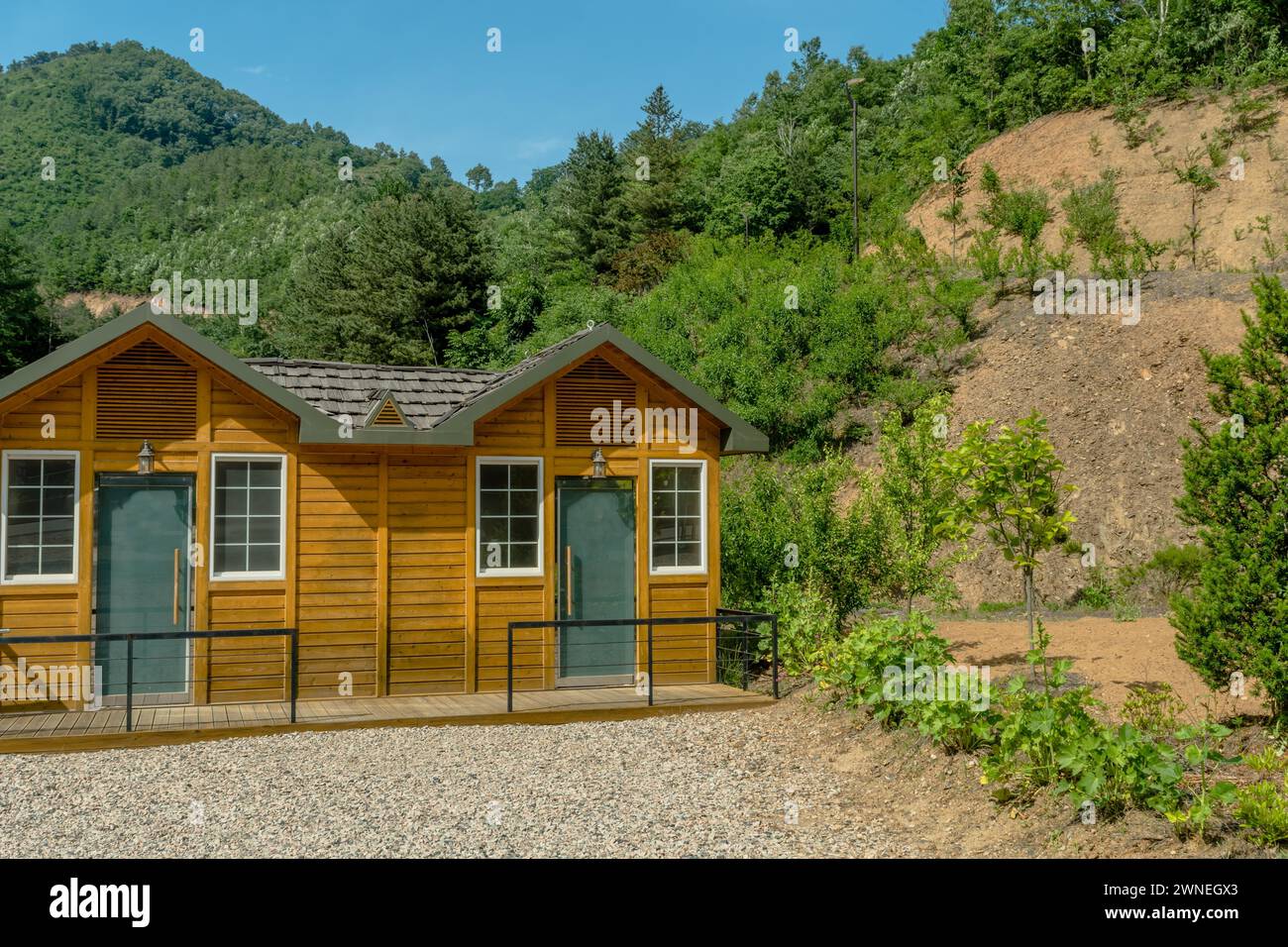Public restrooms with gravel parking lot in mountain roadside park ...