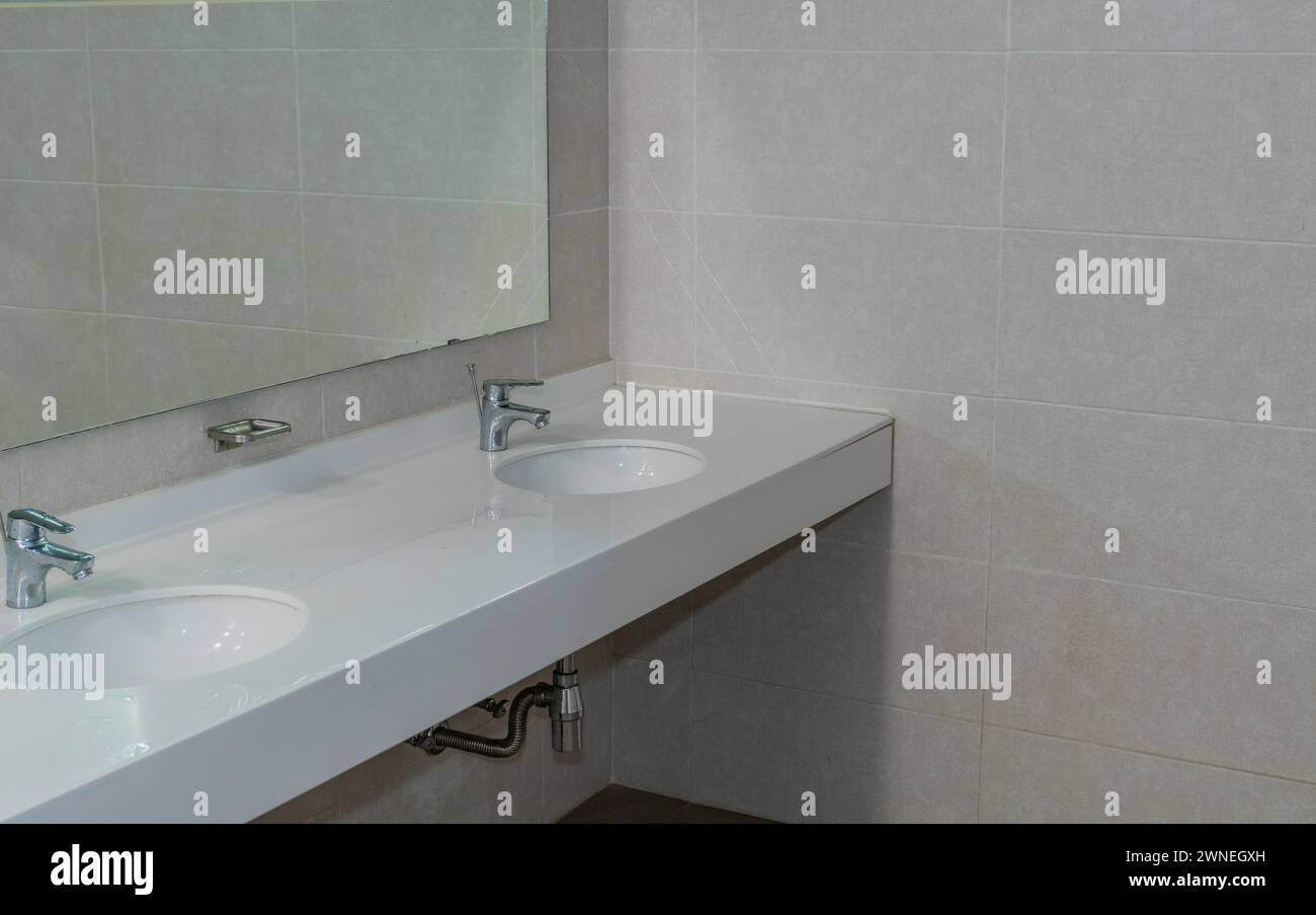 Closeup of double sink and mirror in public restroom in South Korea ...