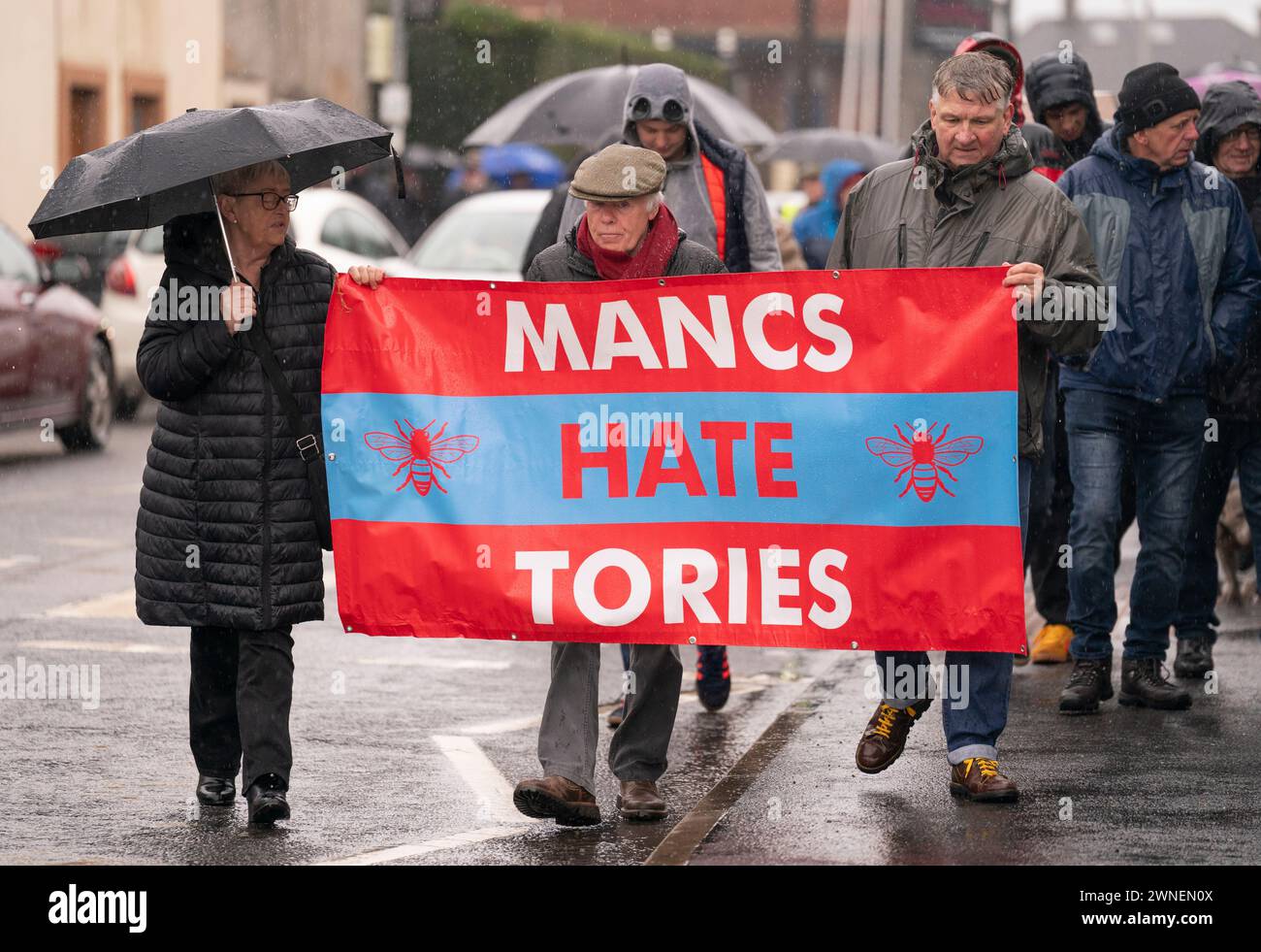 People march through the village of Dodworth during the Miner's strike ...