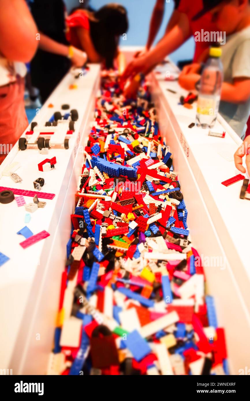Billund, Denmark - 17 June 2023: People are playing with multi-colored ...