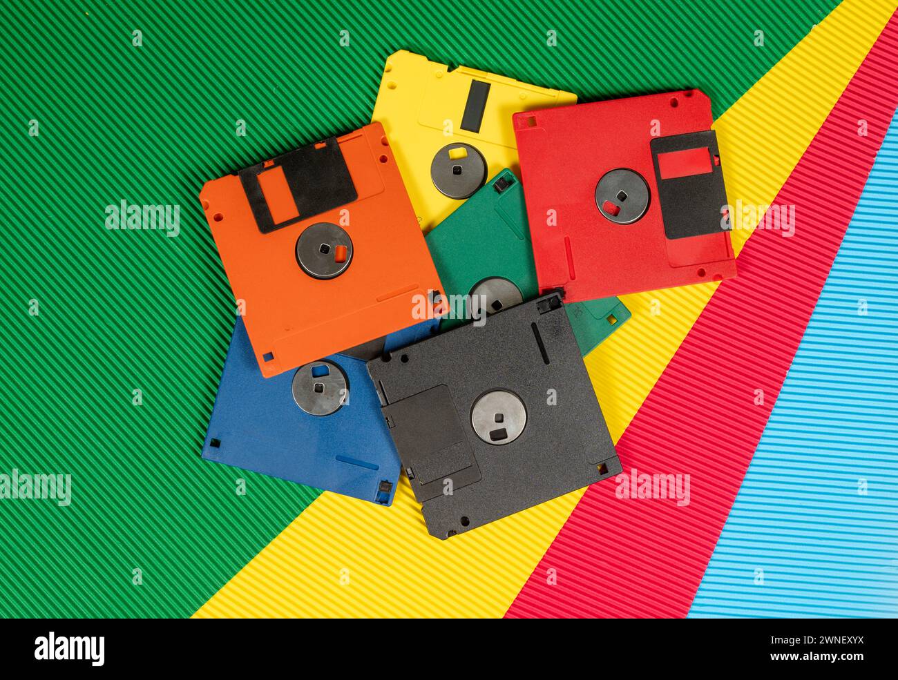 Pile of vintage floppy disks in multi-colored theme technology ...