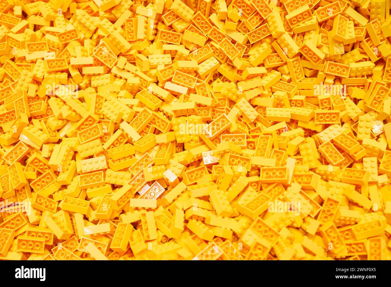 Billund, Denmark - 17 June 2023: Yellow plastic Lego brick background ...