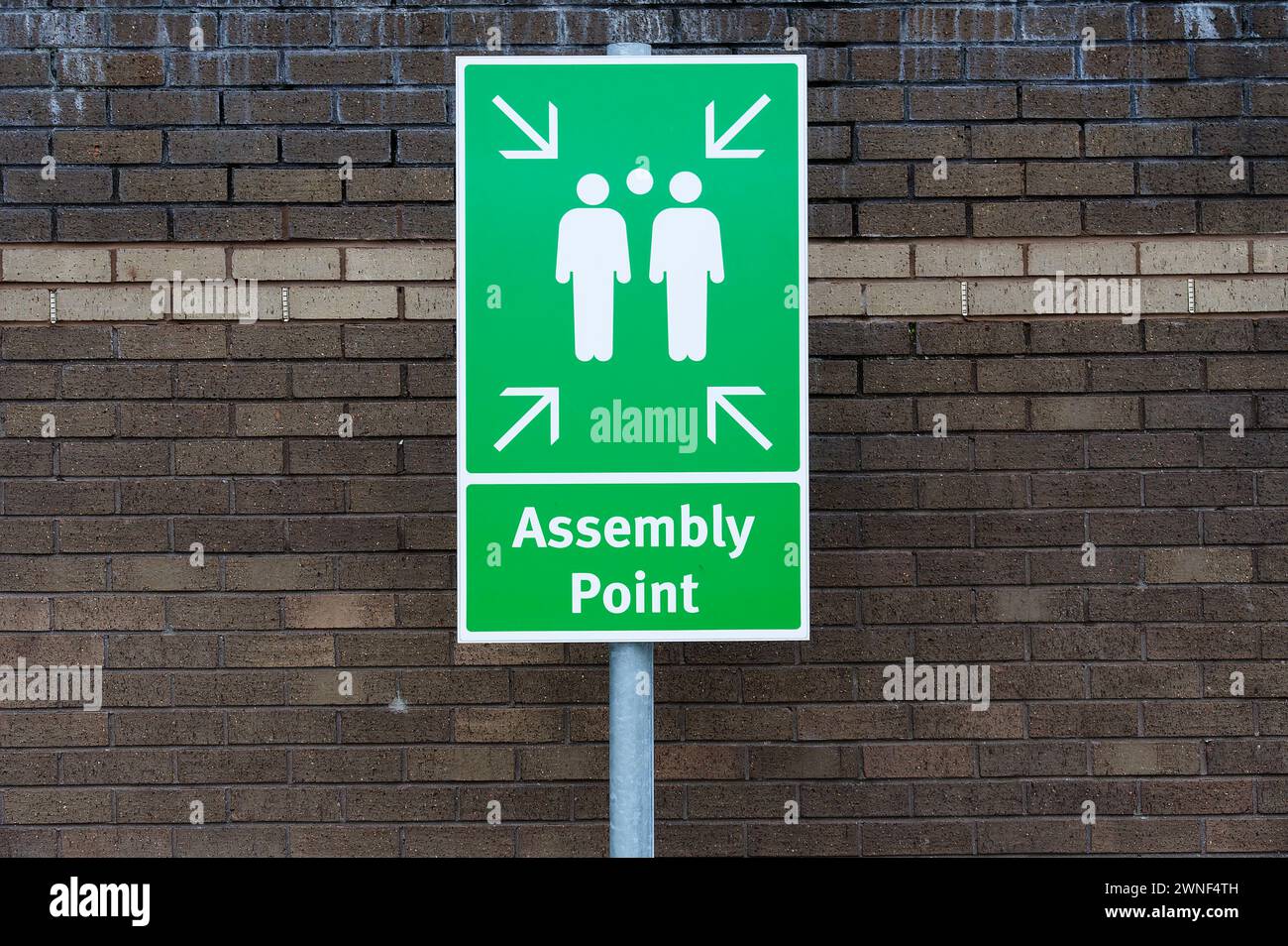 Fire assembly point sign at workplace signpost Stock Photo - Alamy