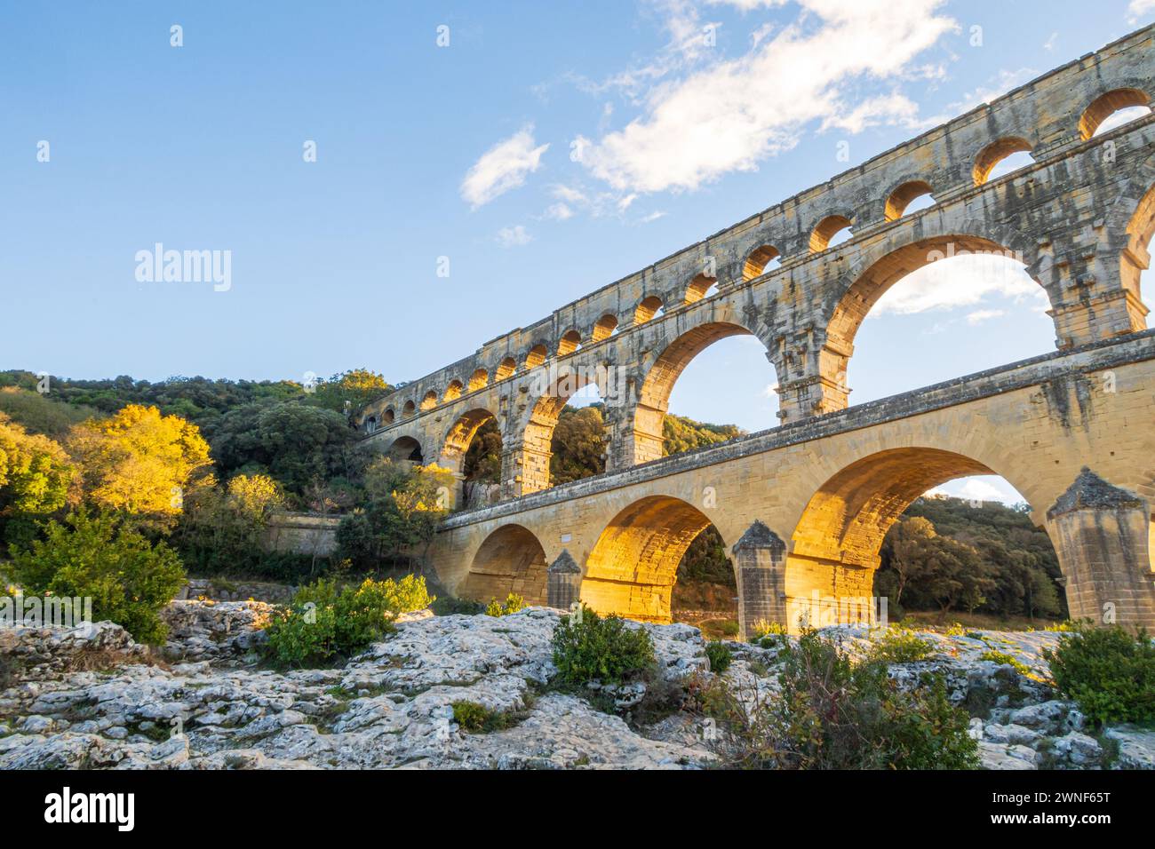 Famous Pont du Gard at setting sun. Ancient Roman three-tiered aqueduct ...