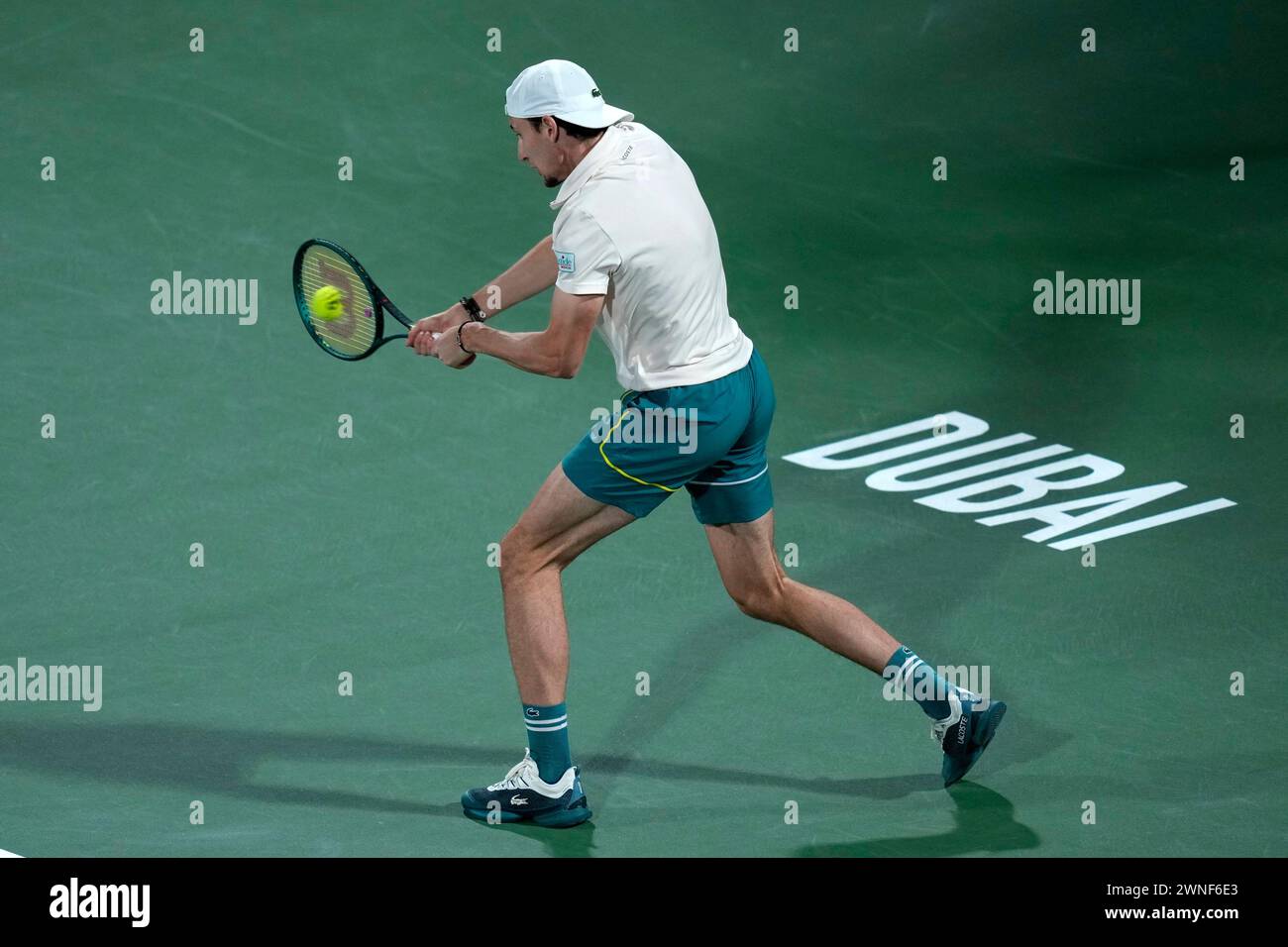 Ugo Humbert of France returns the ball to Alexander Bublik of Kazakhstan during the final match ...