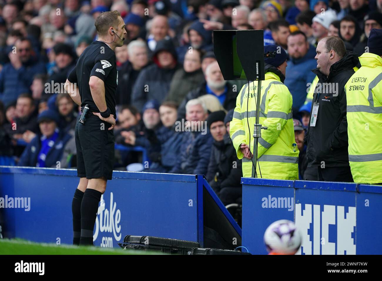 Referee Craig Pawson reviewing VAR before awarding a penalty to Everton ...