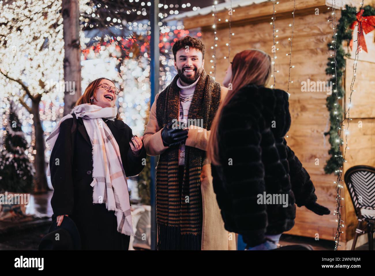 Three young adults are having a bright night out amidst a background of ...