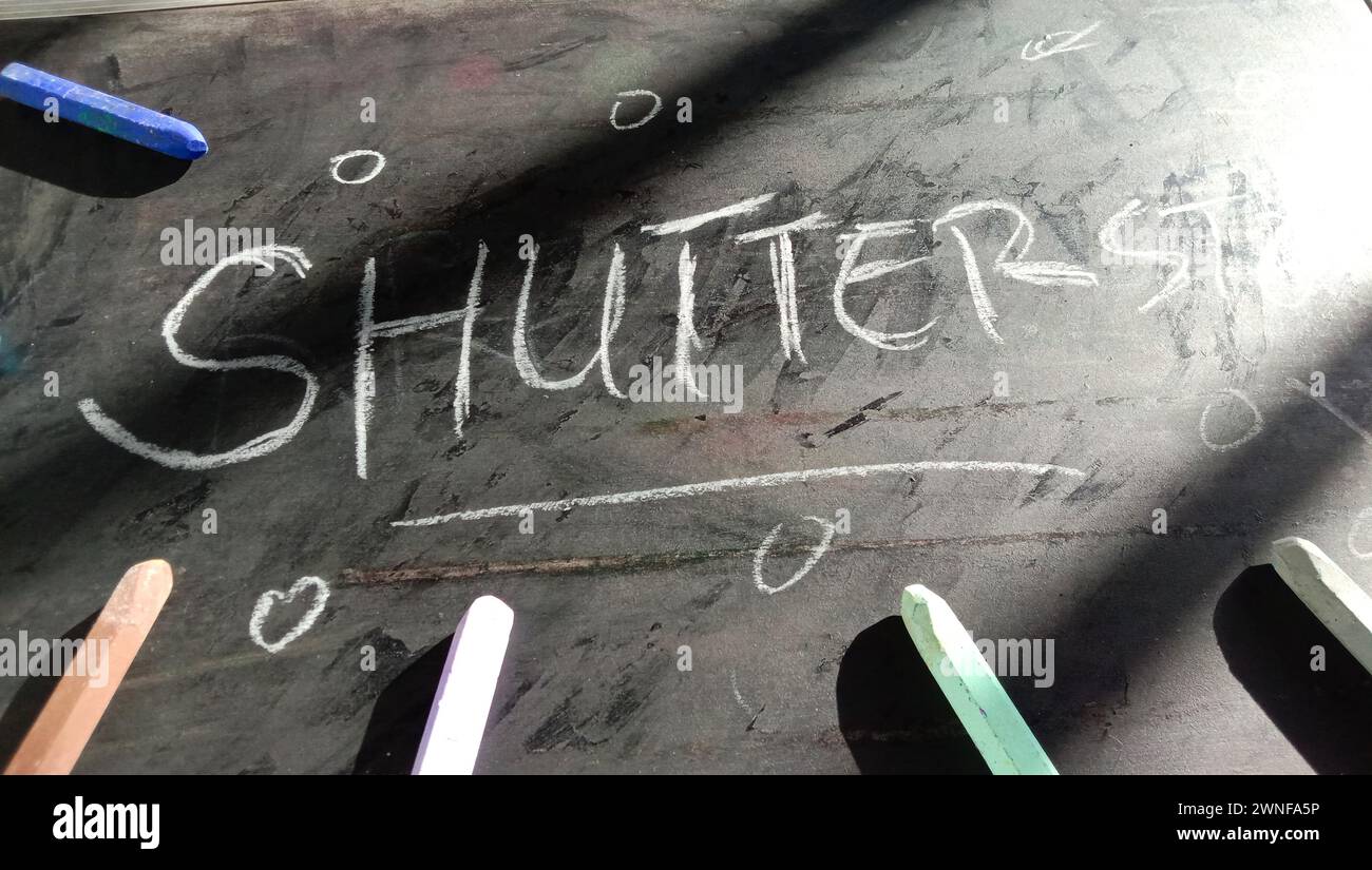 The text "SHUTTERSTOCK" on a black background is written in crayons ...