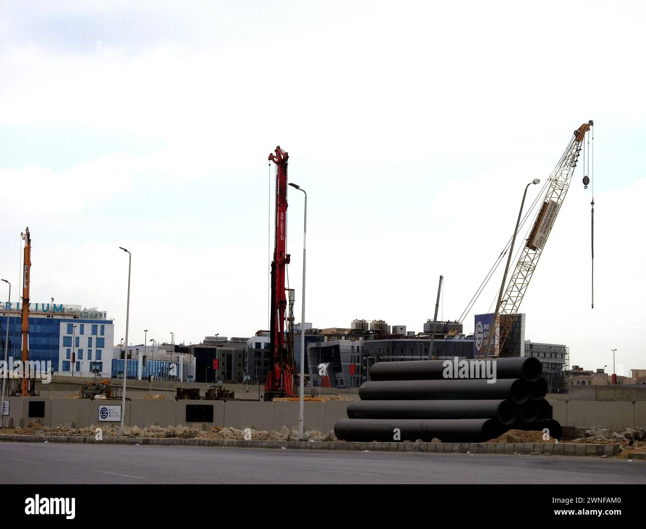 Cairo, Egypt, January 25 2024: cranes and large water pipe parts at a ...
