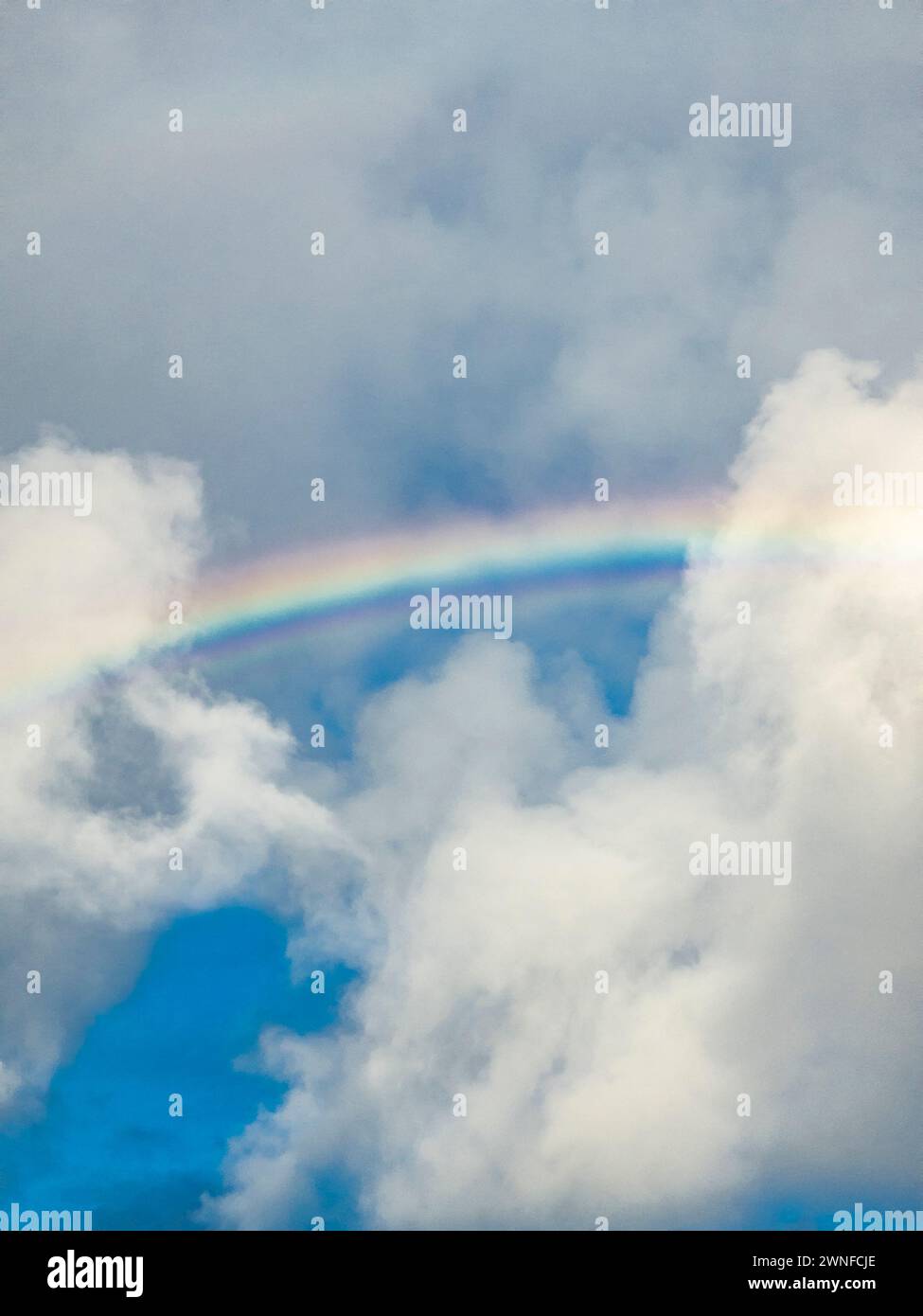 Blue sky rainbows white clouds hi-res stock photography and images - Alamy