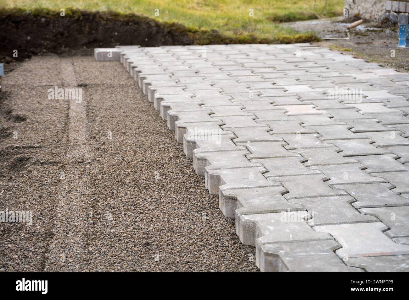 Laying gray concrete paving slabs in house courtyard driveway ...