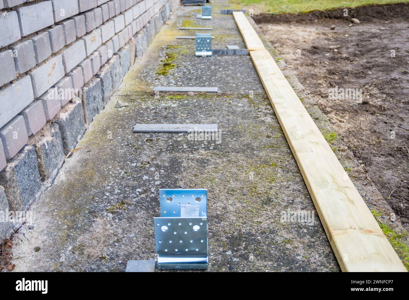 Closeup of iron support on a wooden pillar on the construction site ...