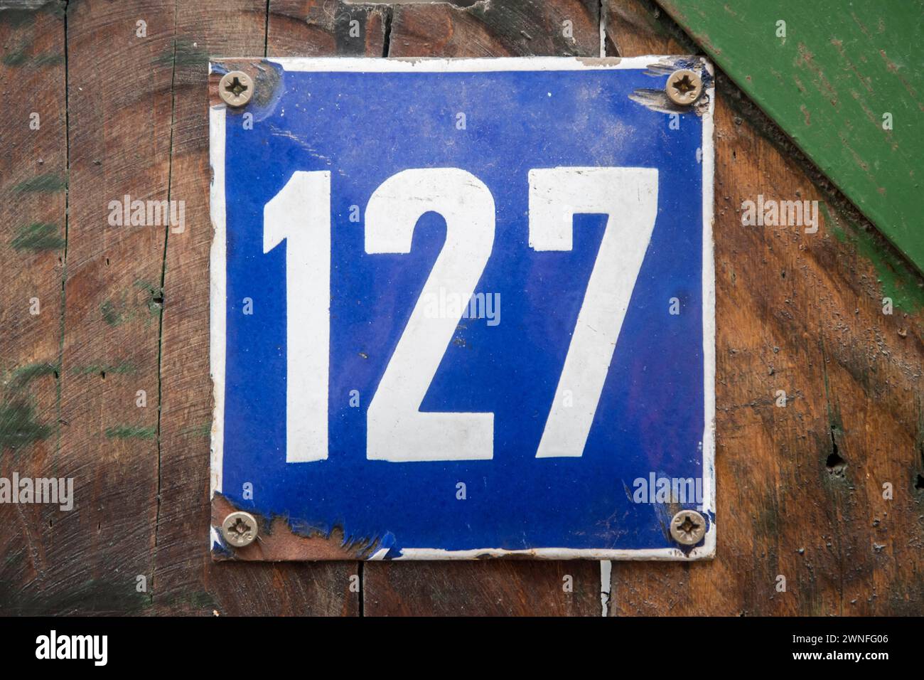 Weathered grunge square metal enameled plate of number of street ...