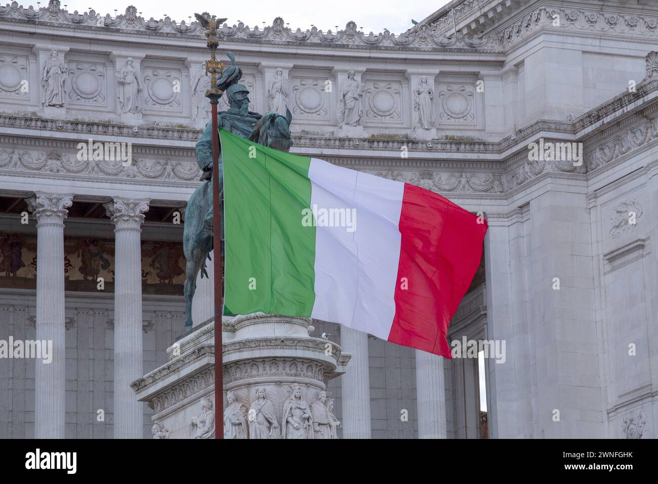 Italian flag against the background of the Vittoriano monument with a ...