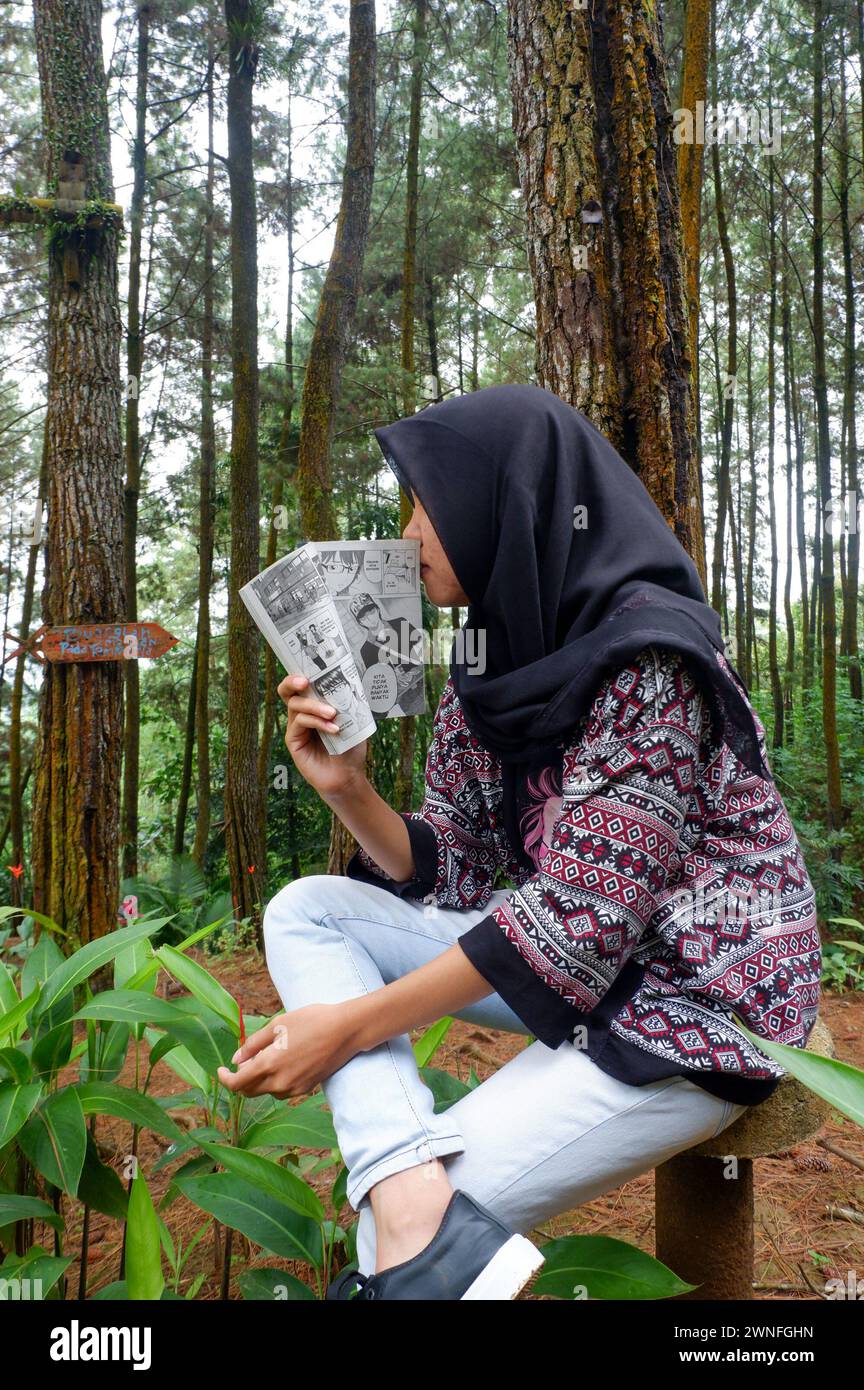 Asian girl reading comic book hi-res stock photography and images - Alamy