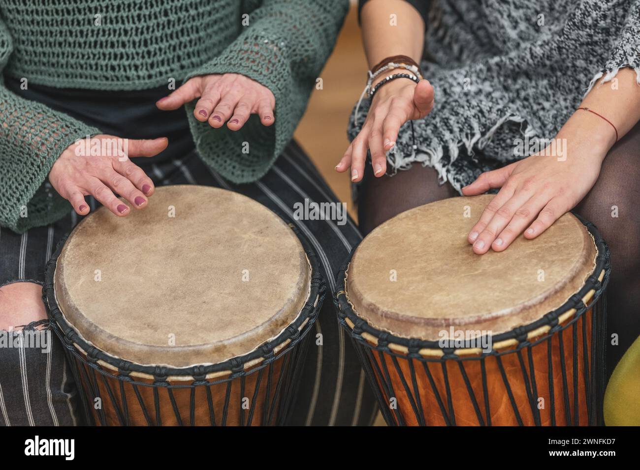 Group of people playing drums during a music therapy lessons, jembe ...
